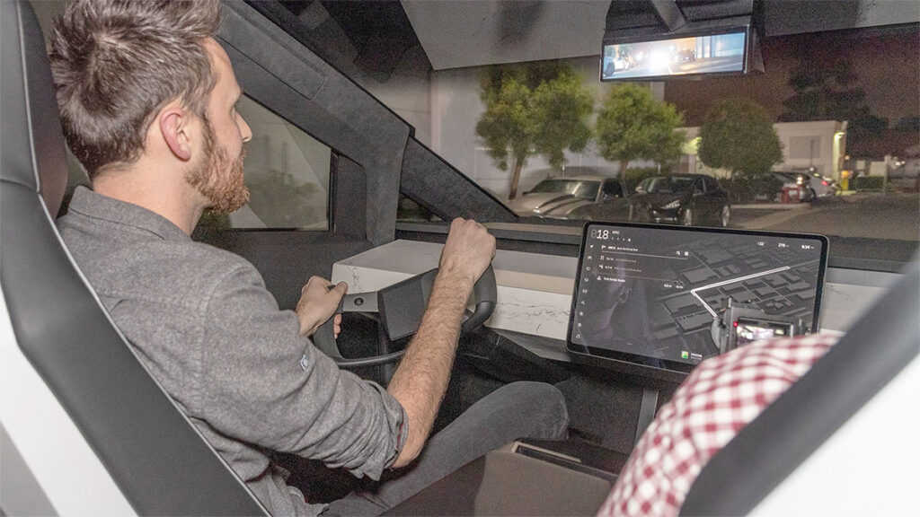 Watch the Cybertruck drive into the Tesla Design Center and beside a ...